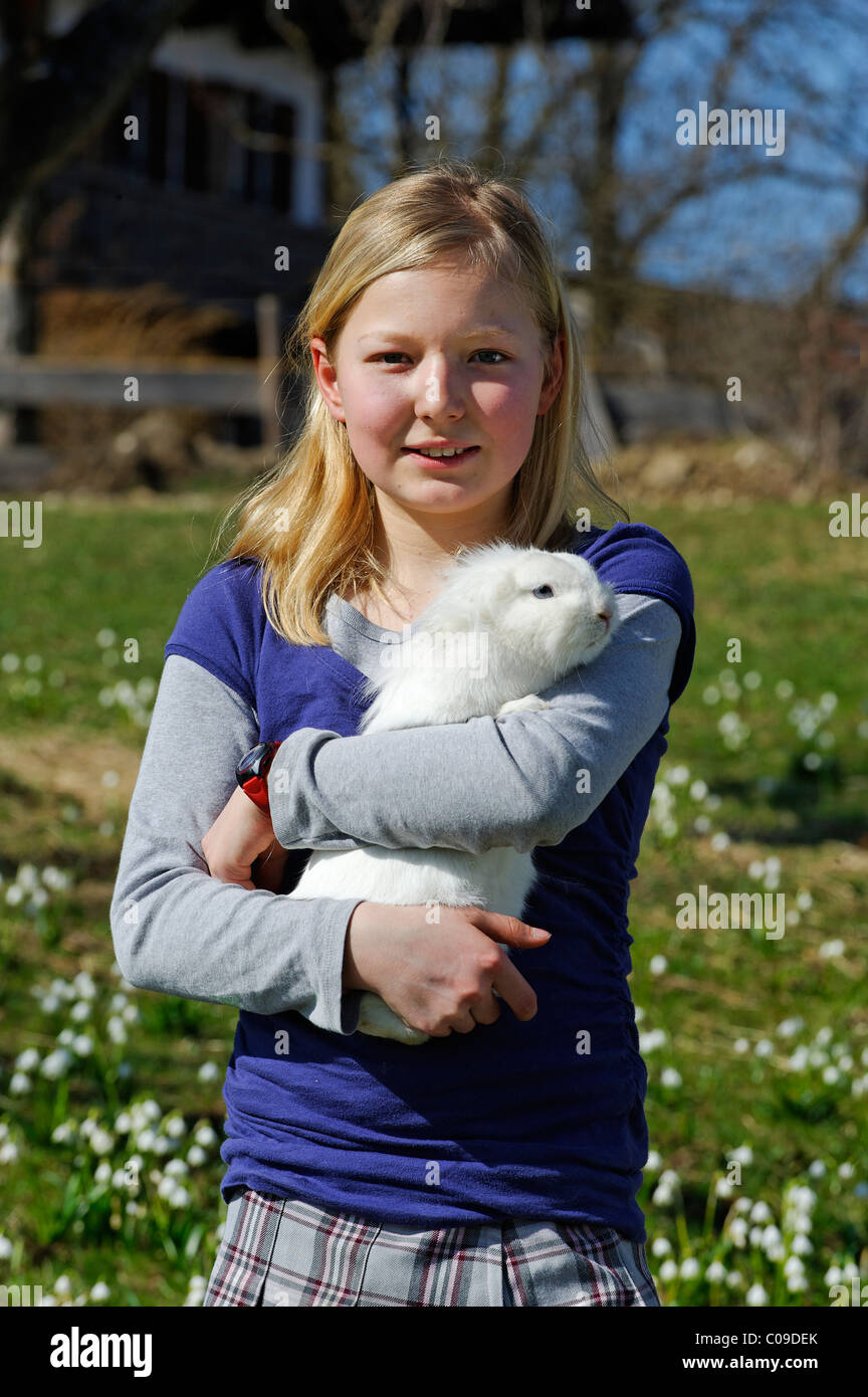 Girl holding a rabbit in her arms Stock Photo - Alamy