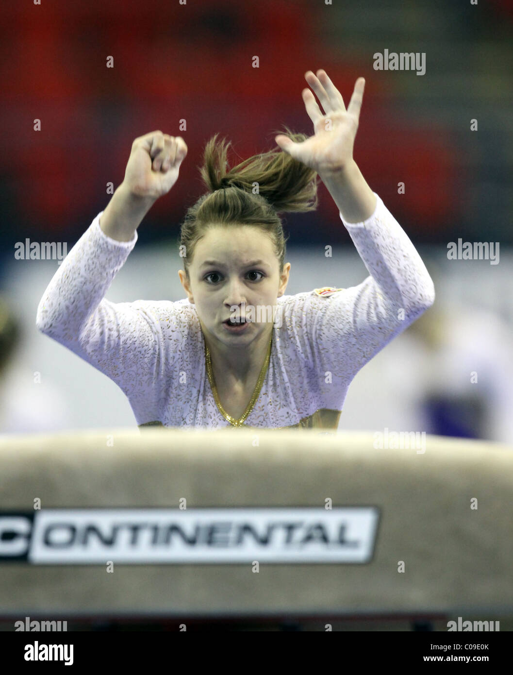 Female Gymnast approaching the vault at speed about to take off and fly ...