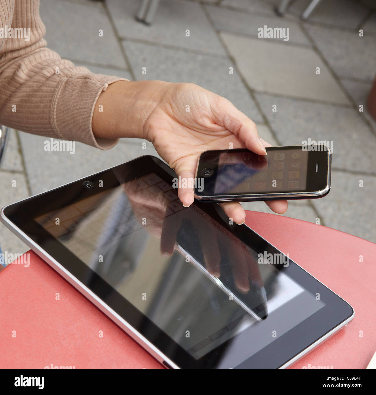 IPad tablet computer and an iPhone mobile telephone for size comparison ...