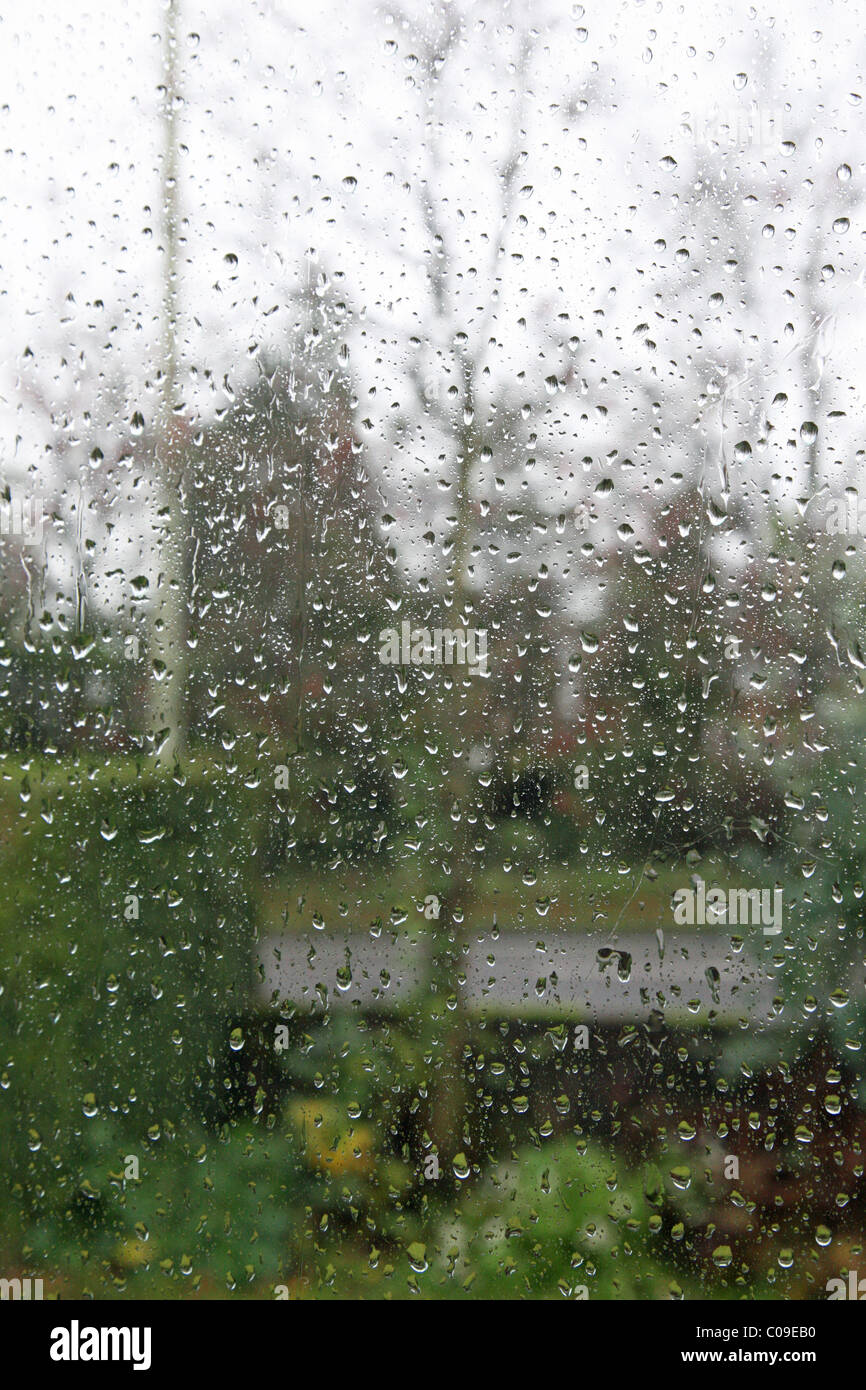 A view out of a rain covered window with rain drops on the window Stock ...