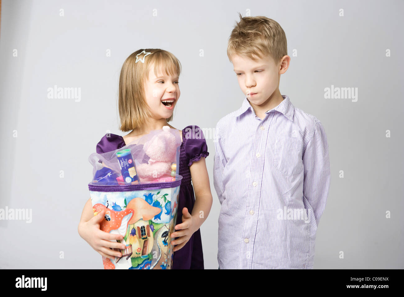 Children with a large cornet of cardboard filled with sweets and little ...