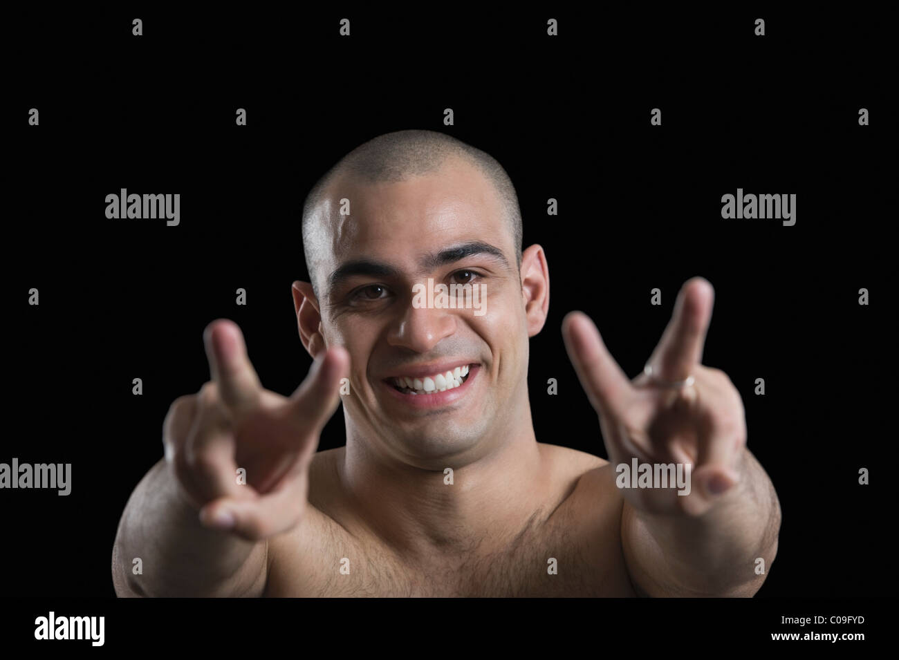 Portrait of a man making peace signs Stock Photo - Alamy