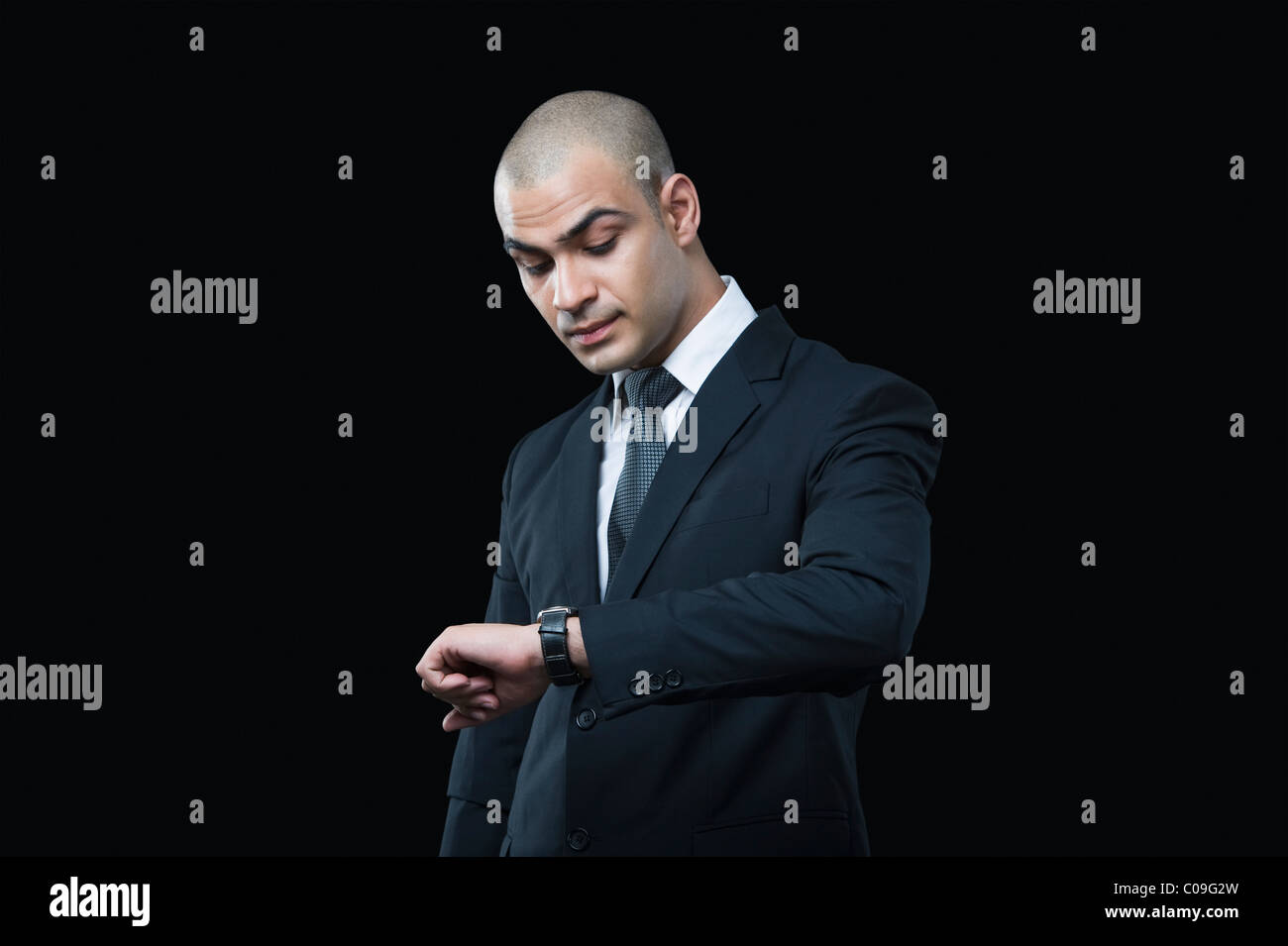 Businessman checking the time Stock Photo - Alamy