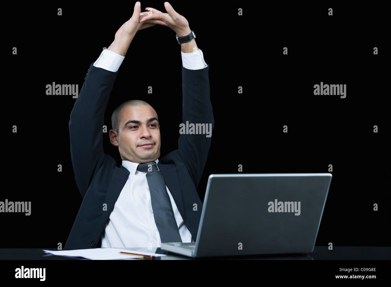 Businessman stretching in office Stock Photo - Alamy