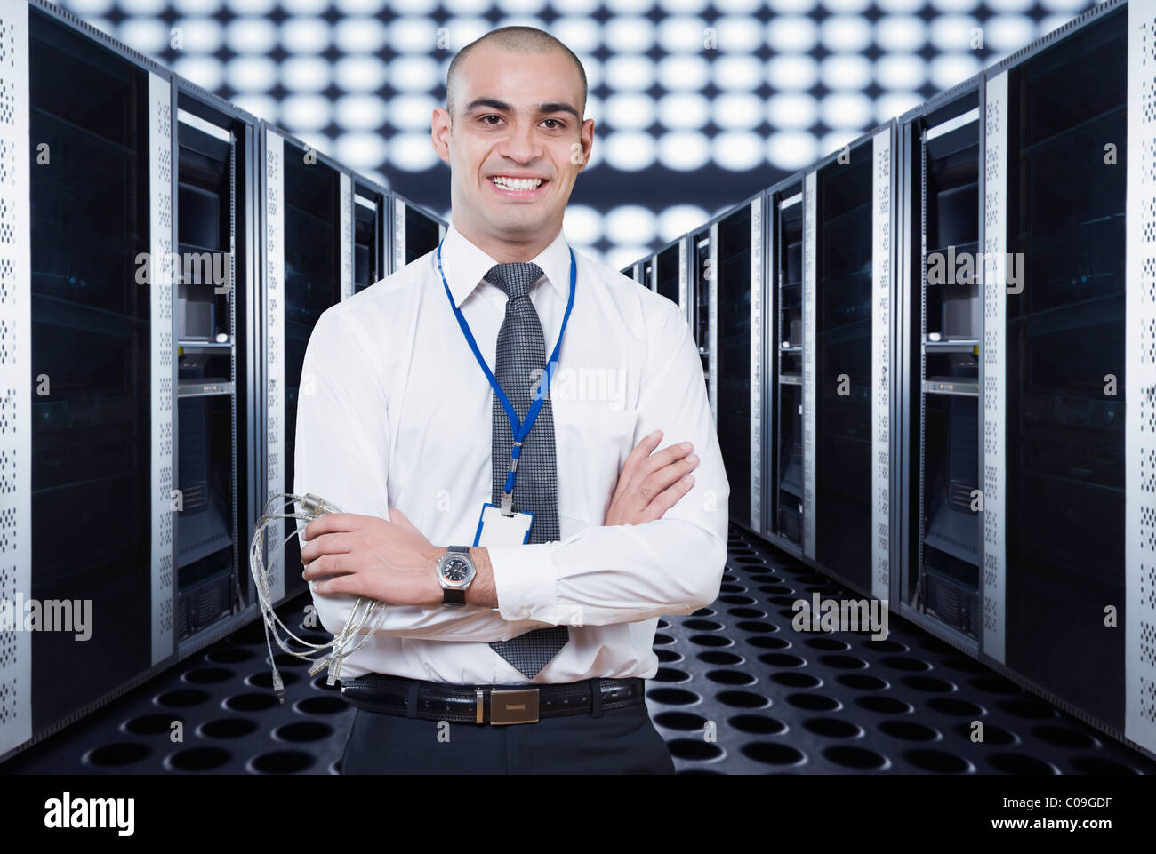 Portrait of a technician smiling in a server room Stock Photo - Alamy