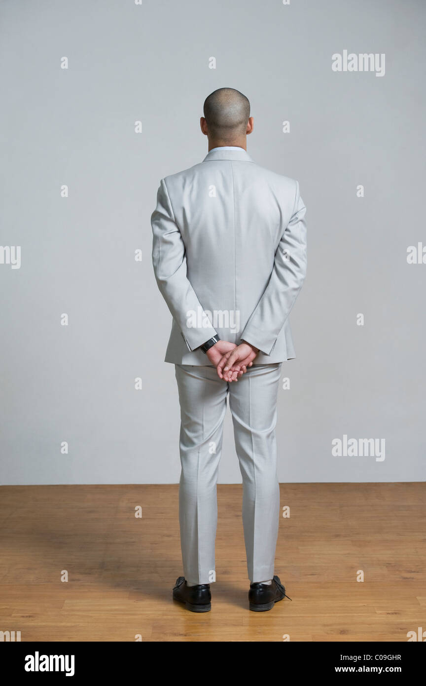 Rear view of a man standing Stock Photo - Alamy