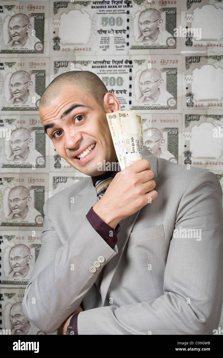 Businessman holding money Stock Photo - Alamy