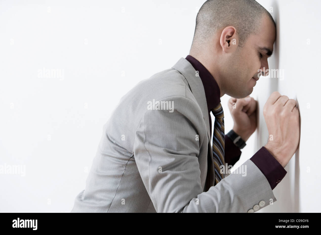 Indian business man standing against wall hi-res stock photography and ...