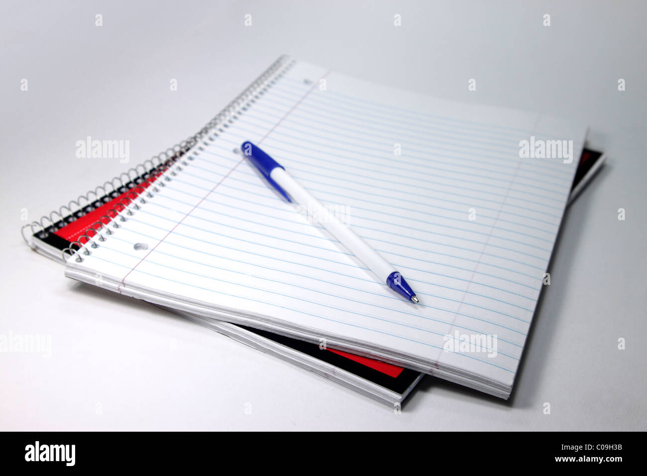 Spiral bound notebook open with pen Stock Photo - Alamy