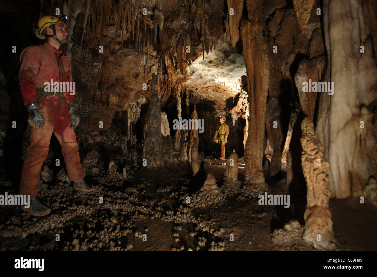 Cave explorers pose infront of cave formations underground in China ...