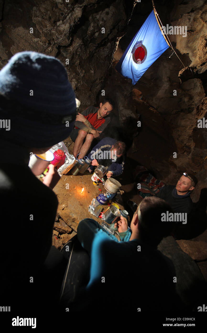 Explorers gather round at an underground camp in a cave in China Stock ...