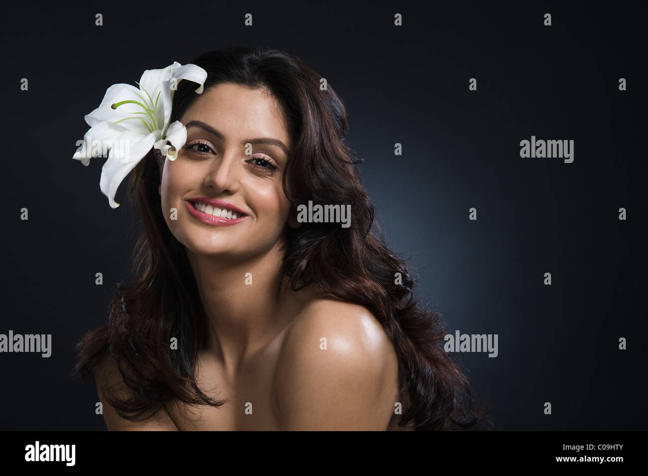 Portrait of a woman wearing a Tiger Lily flower and smiling Stock Photo ...