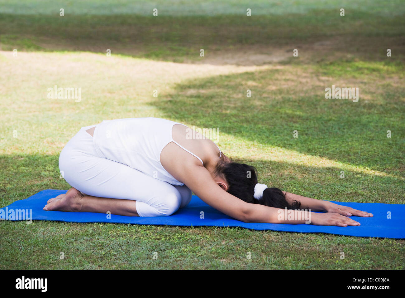 Woman doing Shashankasana pose (Hare Pose Stock Photo - Alamy