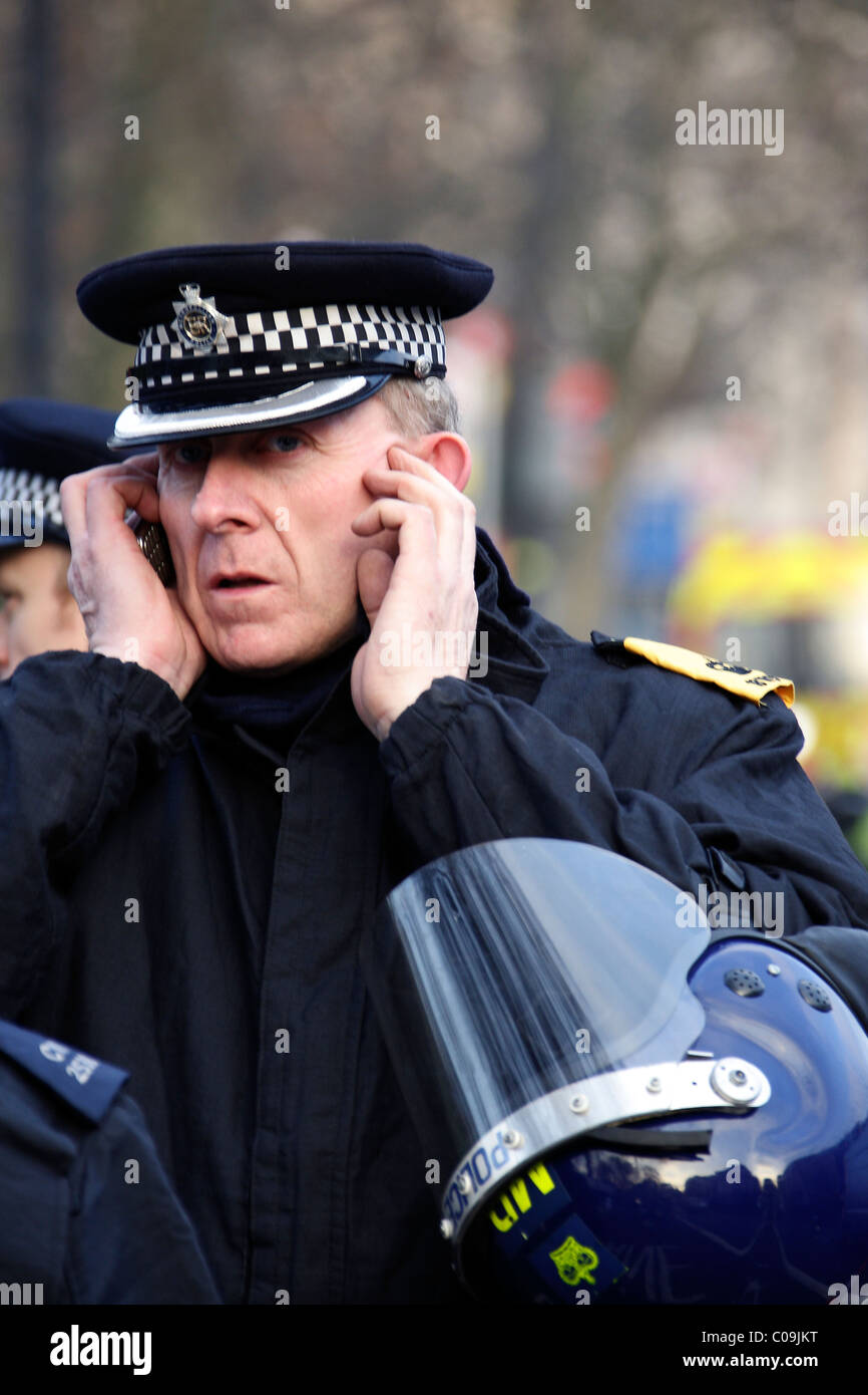 Metropolitan Police Superintendent struggles to hear a phone call Stock ...