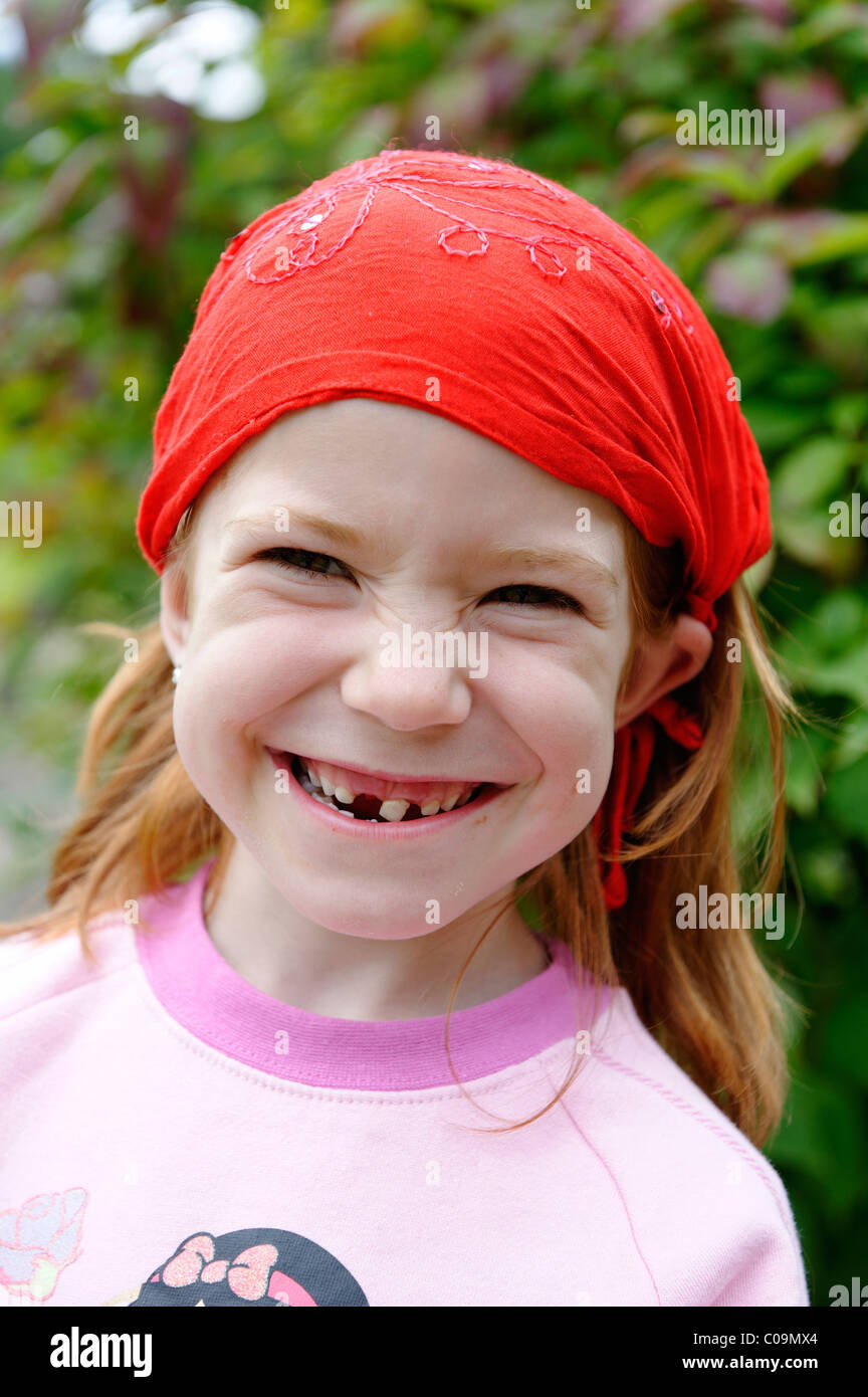 Girl with fallen out tooth and loose tooth Stock Photo - Alamy