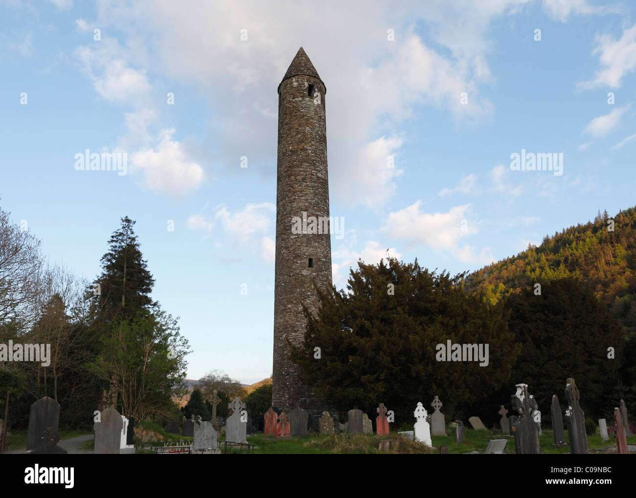 Round tower and cemetery on the Glendalough monastery grounds ...