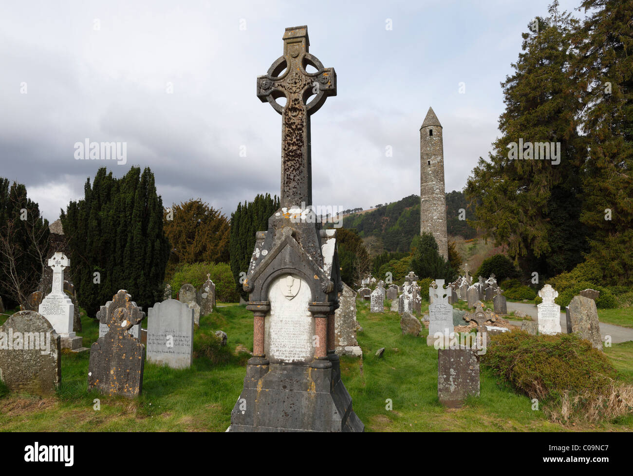 High cross, round tower and cemetery site at Glendalough monastery ...