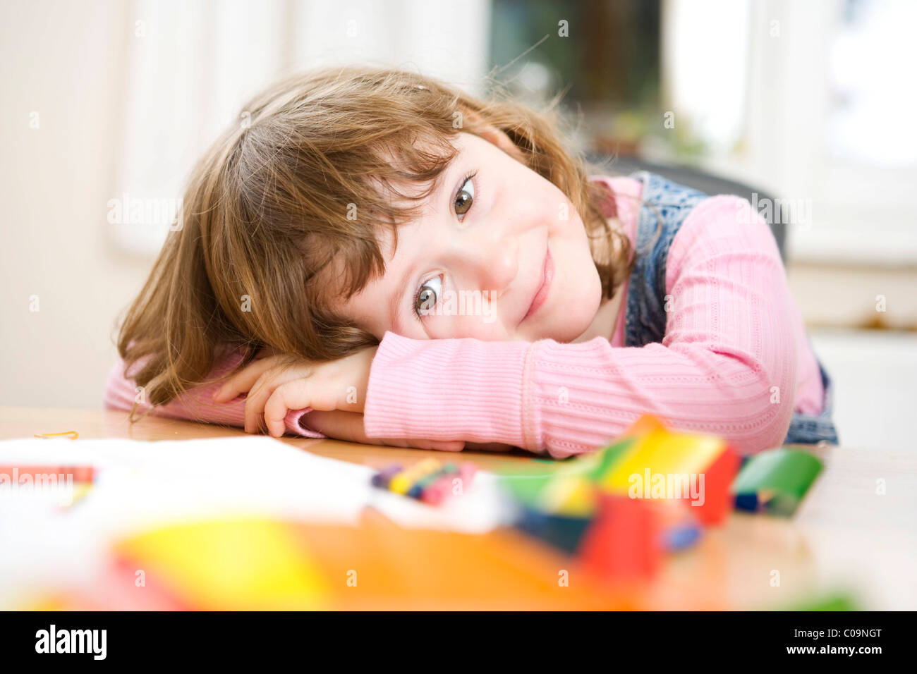 Girl resting head on table hi-res stock photography and images - Alamy