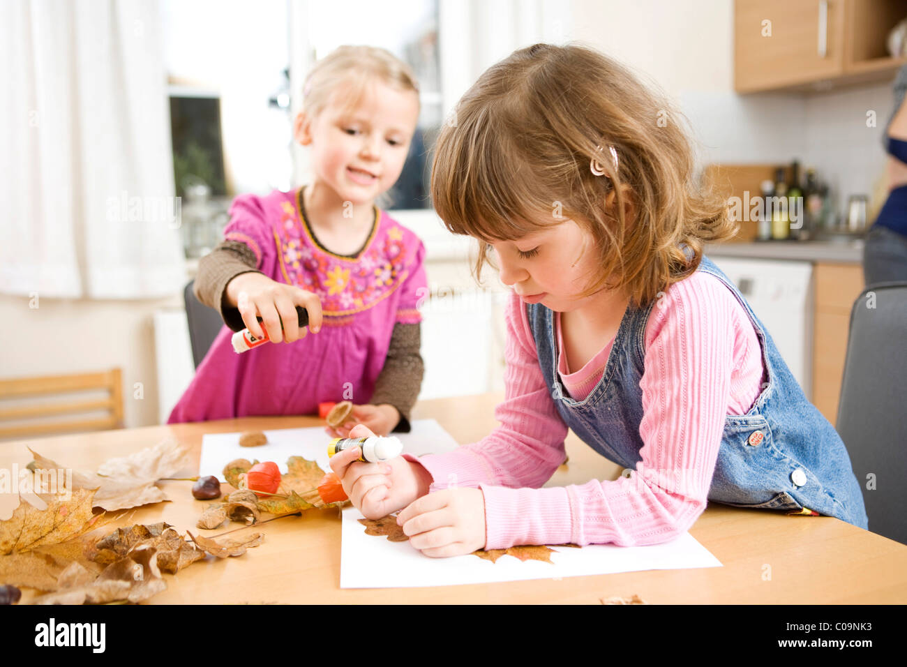 Two girls doing handicrafts Stock Photo - Alamy