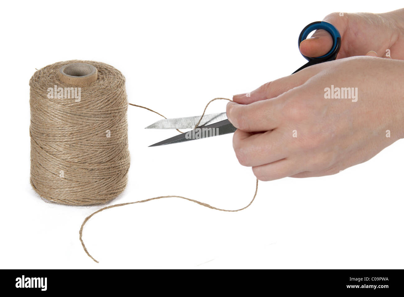 The image of a hand with the scissors cutting a rope, isolated, on a ...