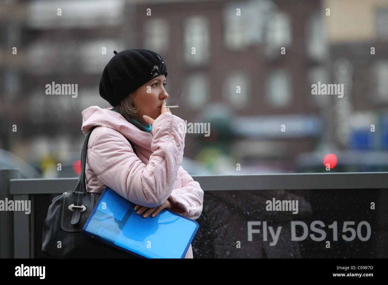 Young woman smoking a cigarette in central Moscow Stock Photo - Alamy