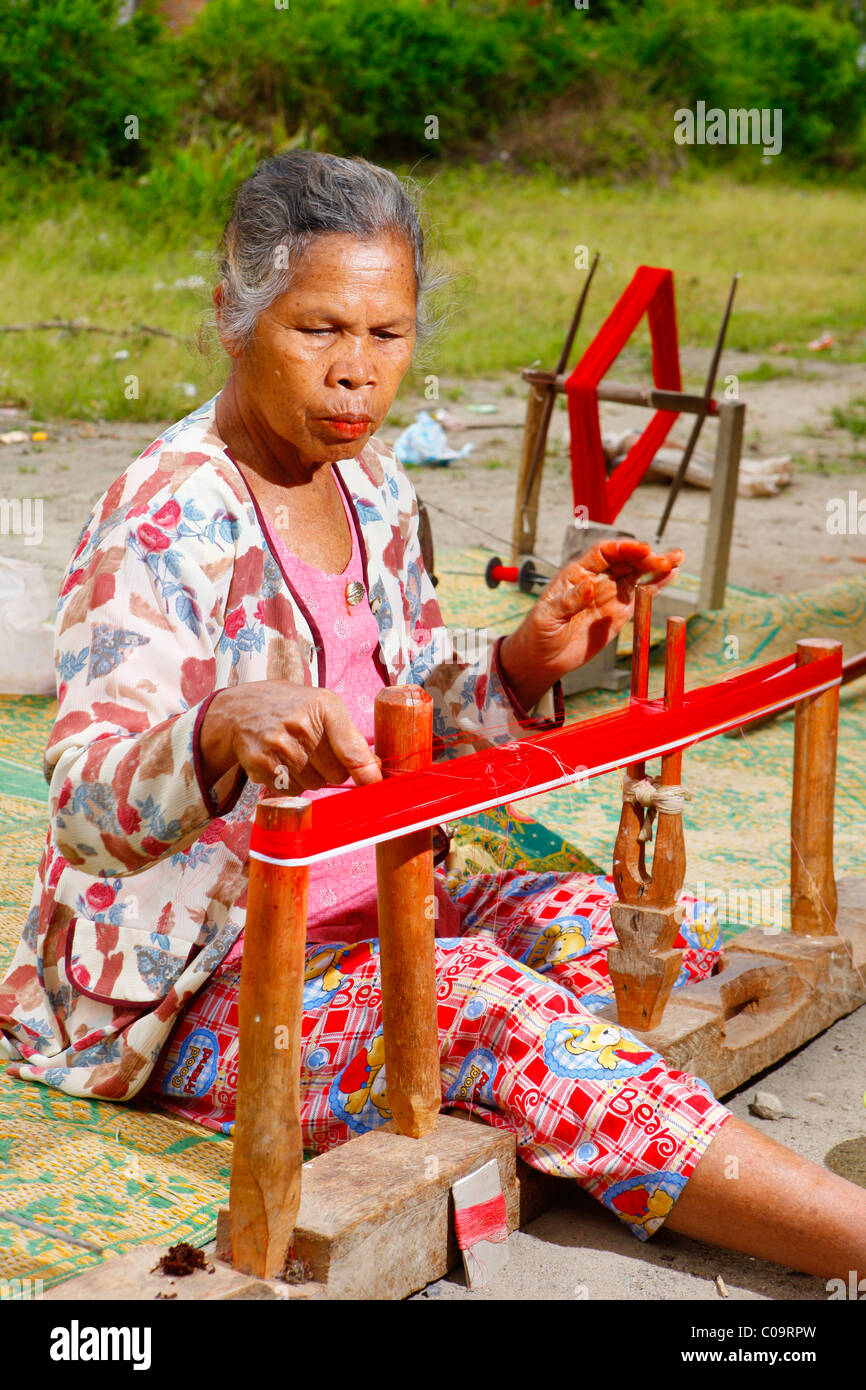 Woman at a spinning wheel, Batak culture, Samosir island, Lake Toba ...