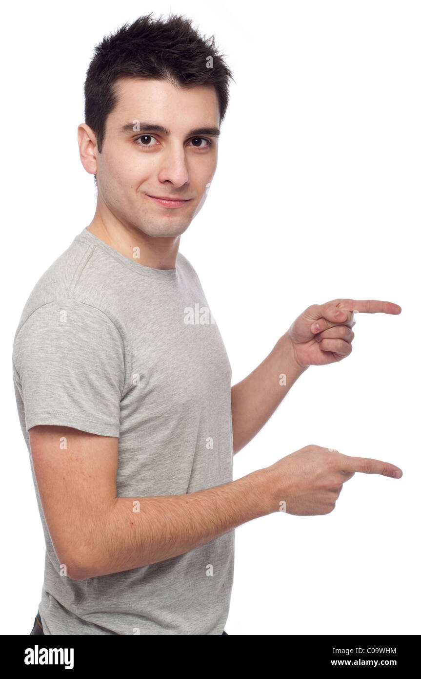 handsome young man pointing at something isolated on white background ...