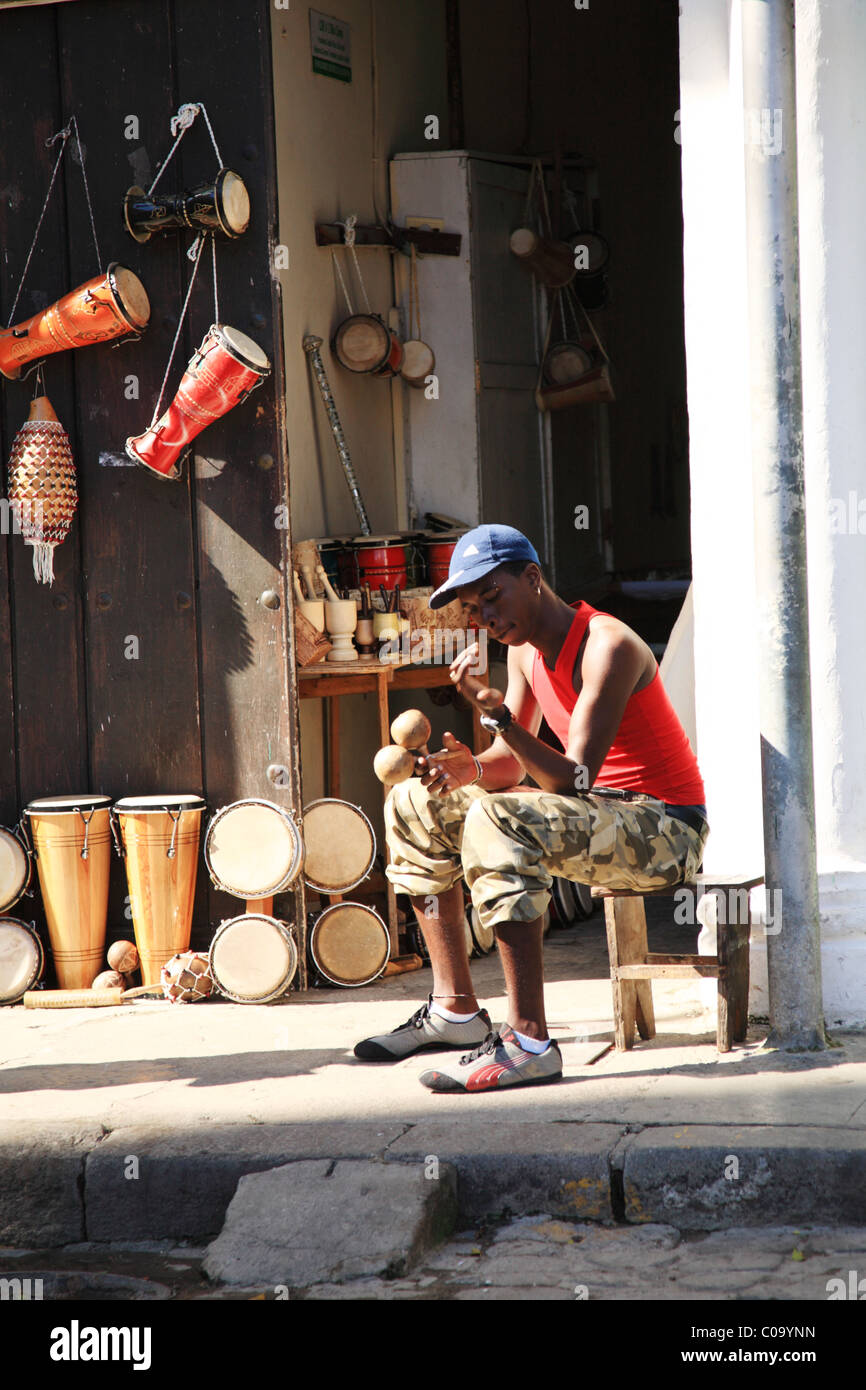 Man sat outside musical instrument shop in Havana, Cuba Stock Photo - Alamy