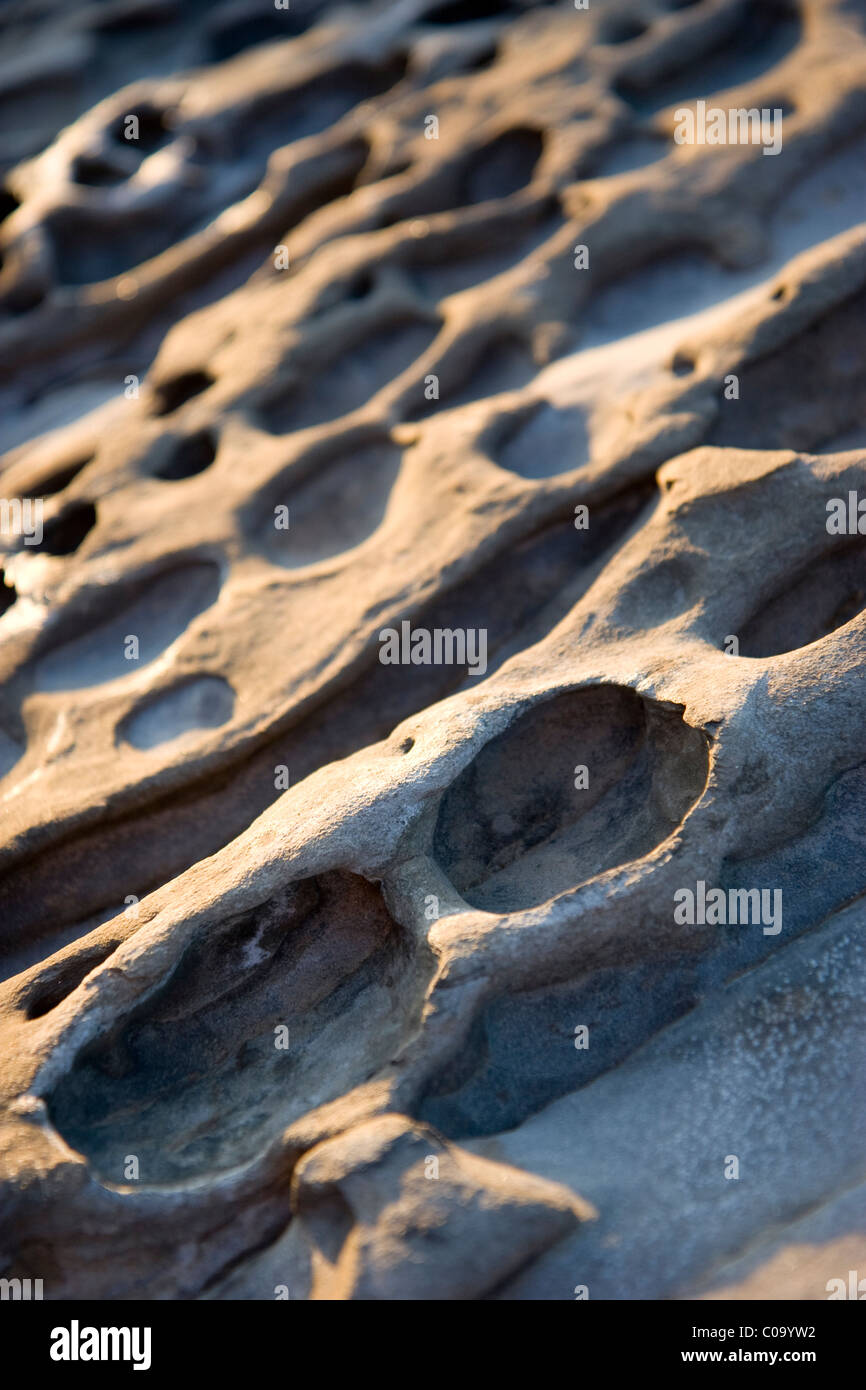 Rough rock face in golden sunset Stock Photo - Alamy