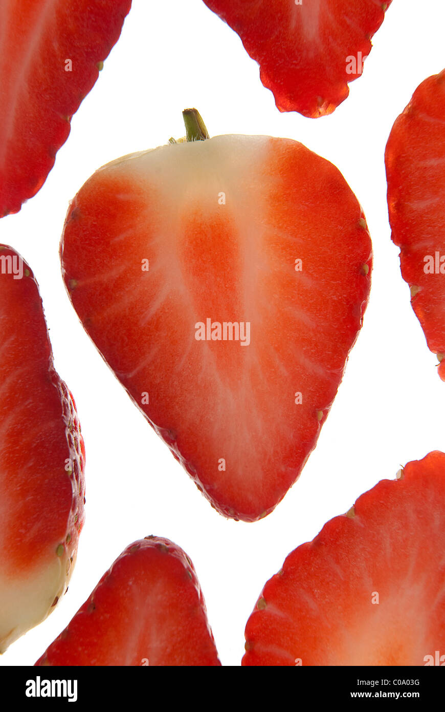 Strawberry cut by segments isolated on white background Stock Photo - Alamy