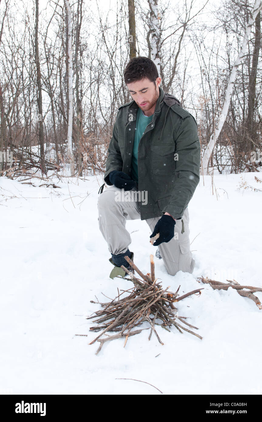 Man making breaking and building campfire Stock Photo - Alamy