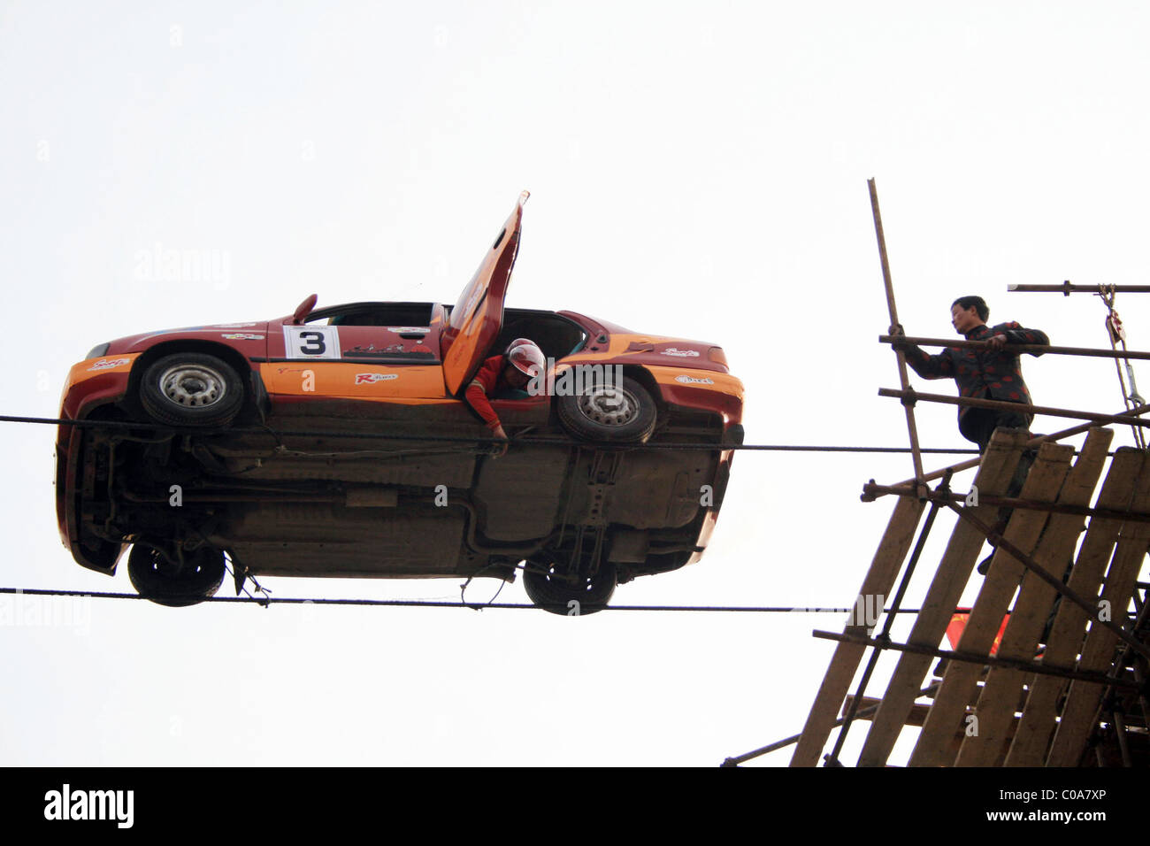 DRIVER TAKES A TIGHT-ROPE ROUTE This mad motorist will drive his car ...