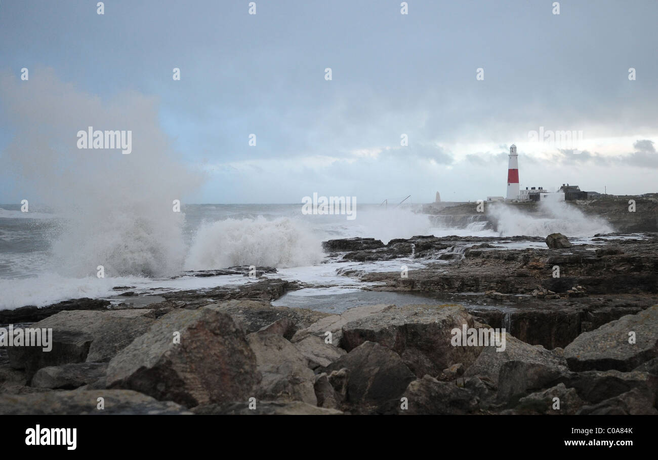 Waves crash around the Portland Bill lighthouse as Britain is hit by ...