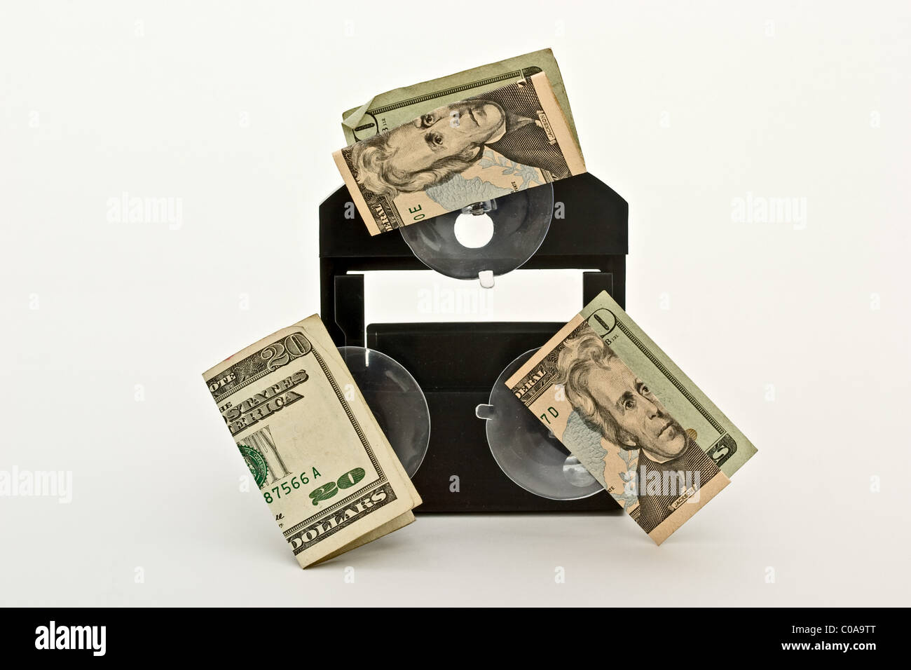 American money stuck to suction cups on a black plastic wall mount ...