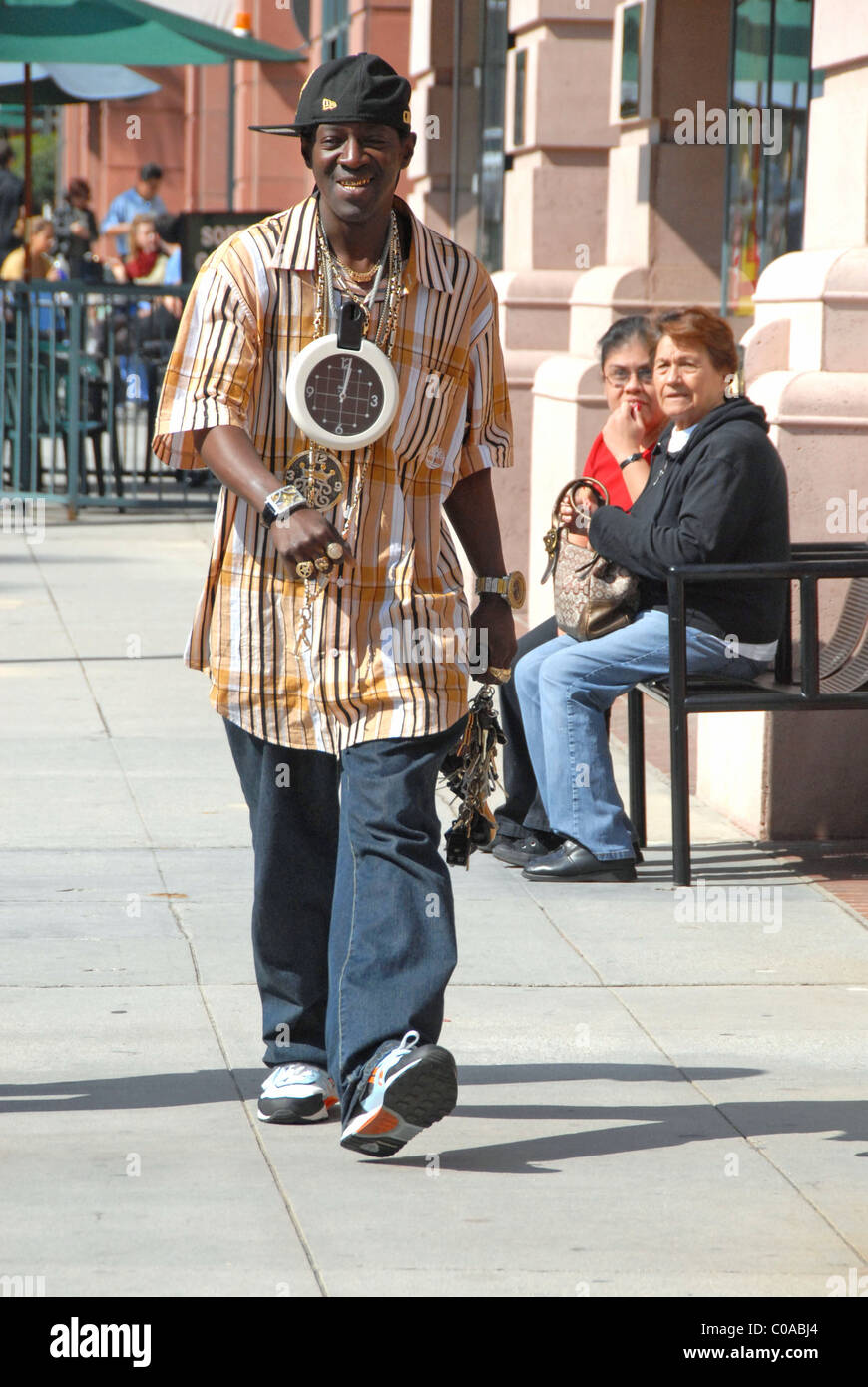 Flavor walks around Beverly Hills with a large clock hanging from his ...