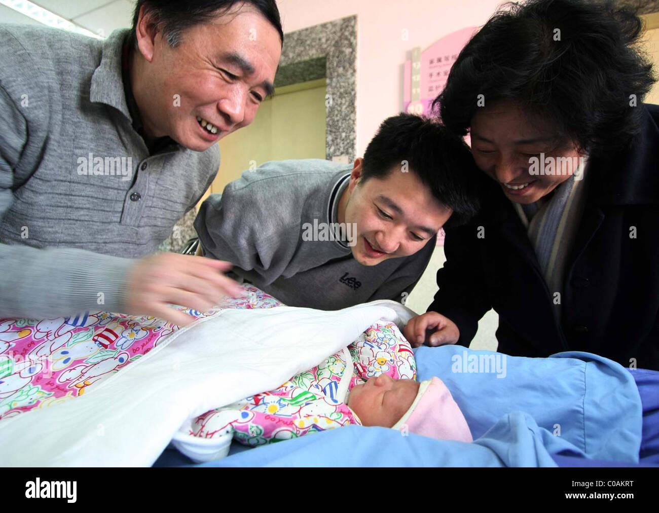 FAMILY CELEBRATE UNIQUE BIRTH An ecstatic family celebrates the safe ...