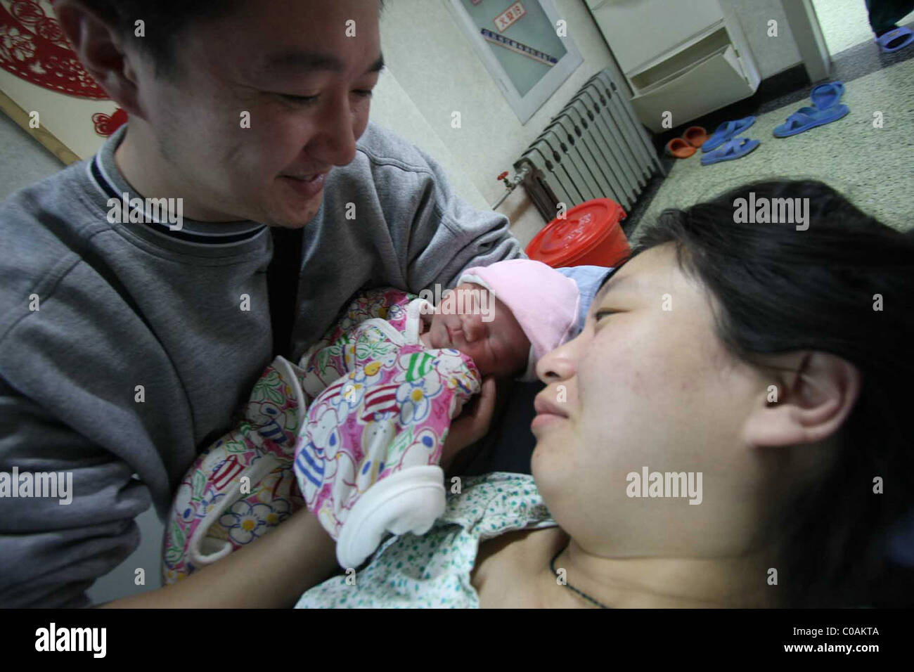 FAMILY CELEBRATE UNIQUE BIRTH An ecstatic family celebrates the safe ...