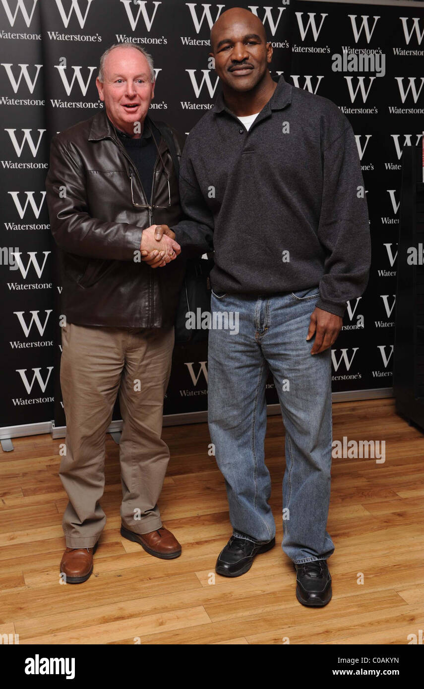 Evander Holyfield with a fan signs copies of his new book 'Becoming ...