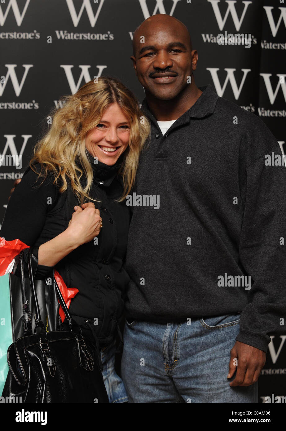 Evander Holyfield with a fan signs copies of his new book 'Becoming ...