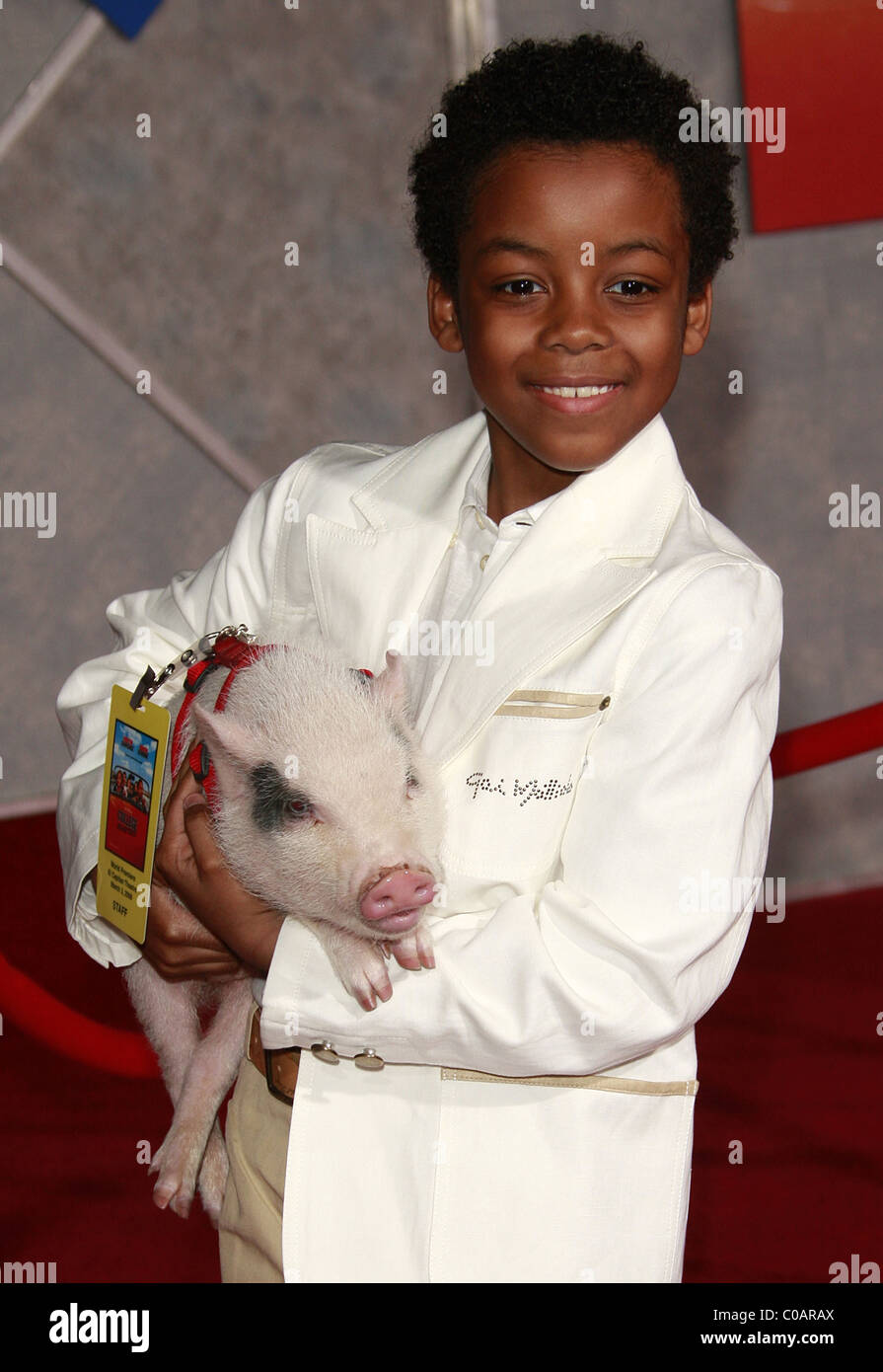 Eshaya Draper with piglet Premiere of 'College Road Trip' at El Capitan ...