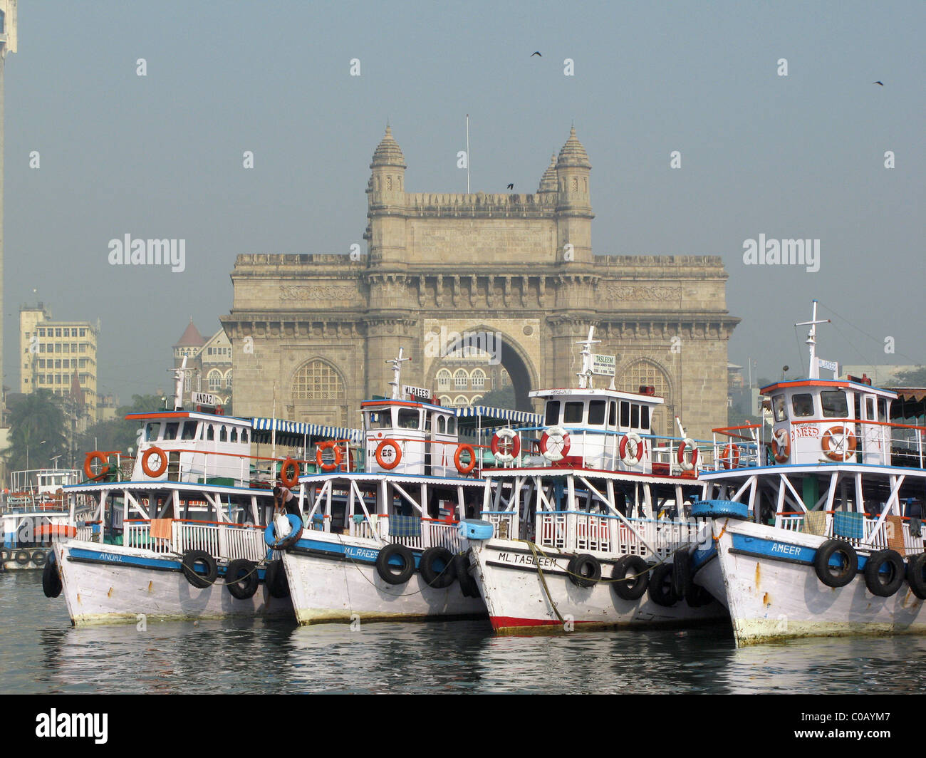 India.Passenger boats at Mumbai harbour next to Gate Of India monument ...