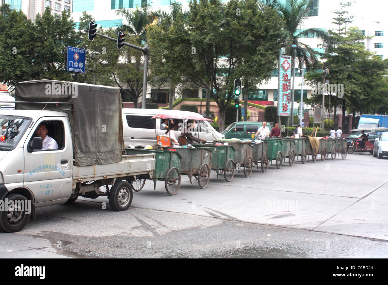 Rubbish collection - Chinese style A 'bendy' Garbage truck works its ...