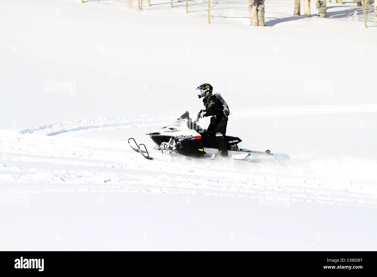Snowmobile on mountain in winter getting ready jump over a dangerous ...