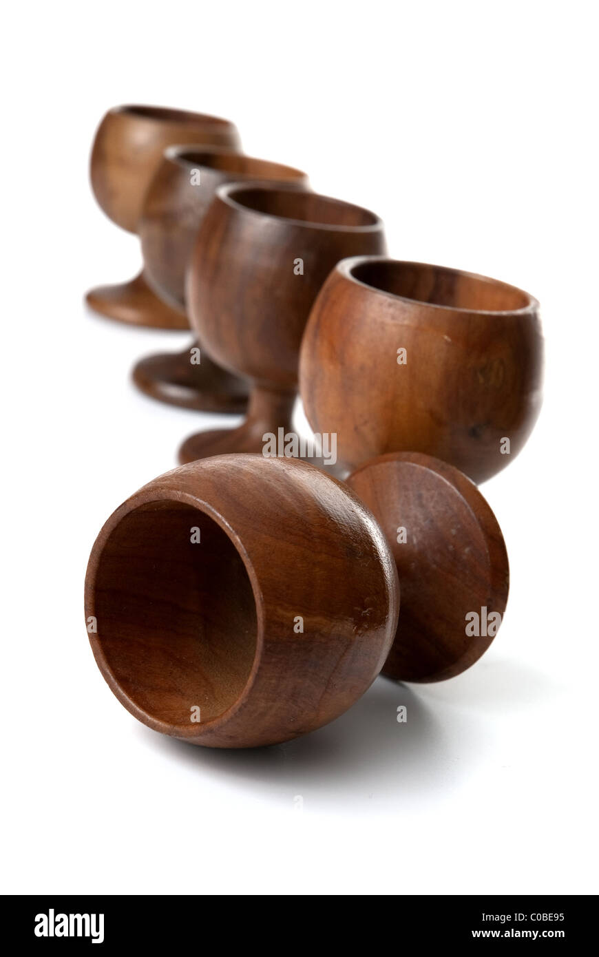 Wooden cups aligned isolated on white background Stock Photo - Alamy