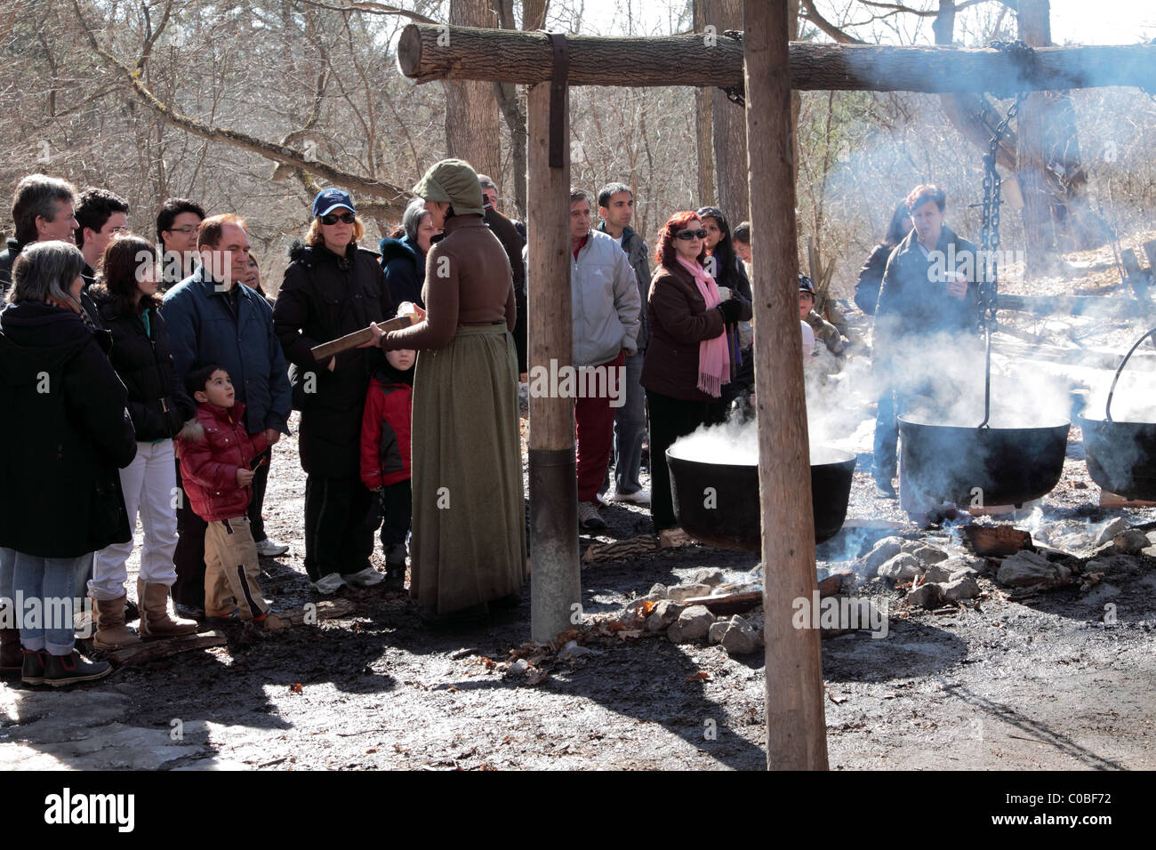 Woman demonstrating how to boil maple sap to make syrup in the ...