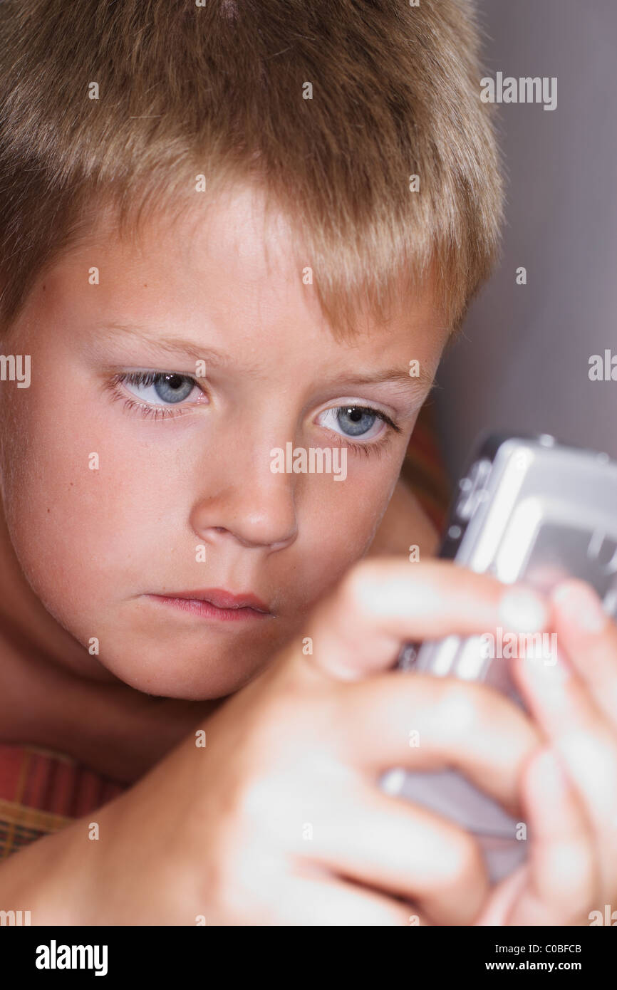 boy texting on mobile phone Stock Photo - Alamy