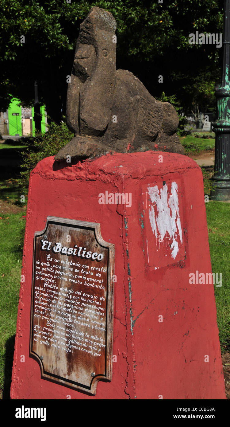 Brown effigy on red plinth with information plaque of El Basilisco ...