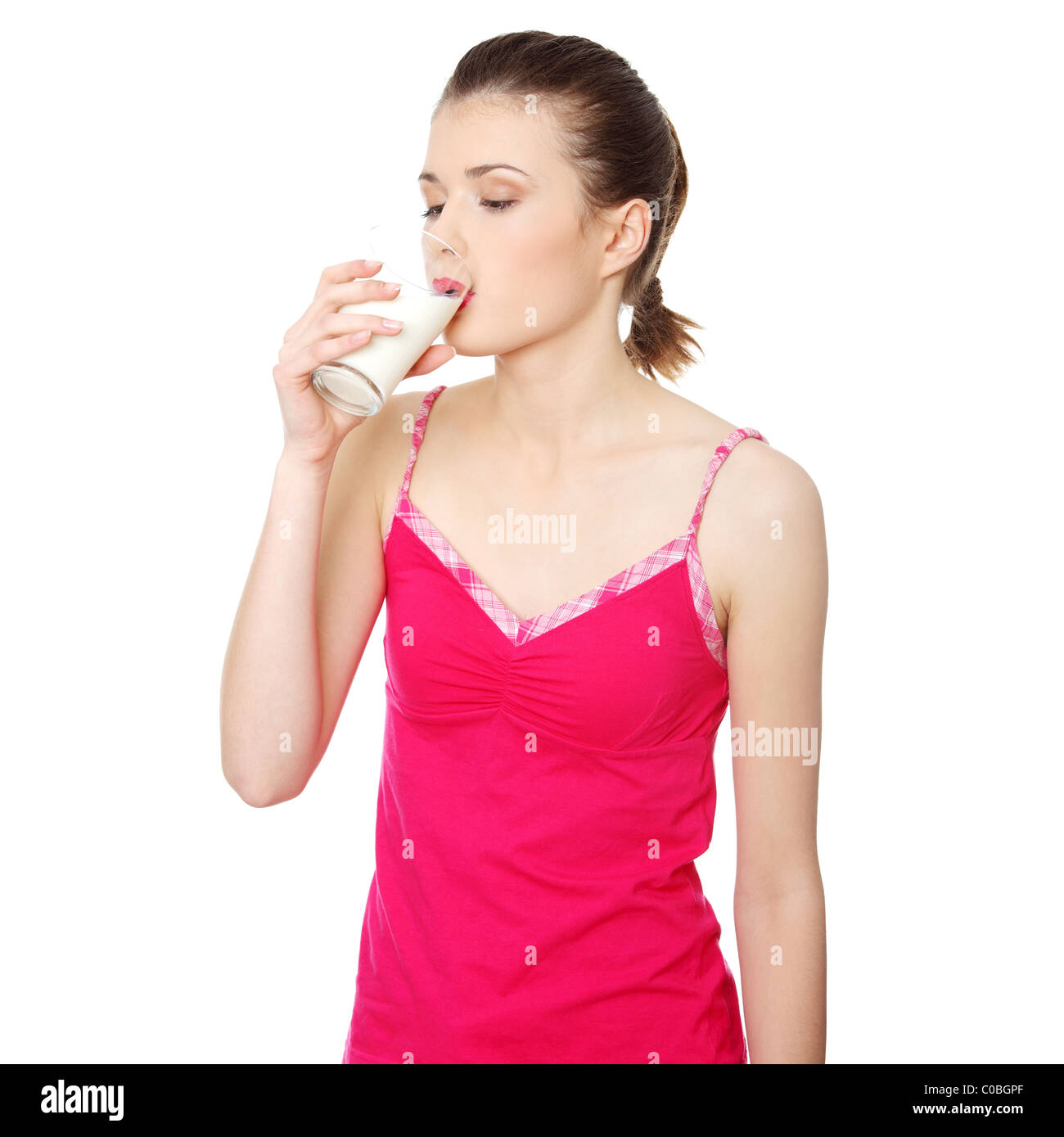 Teen woman drinking water isolated on white background Stock Photo - Alamy