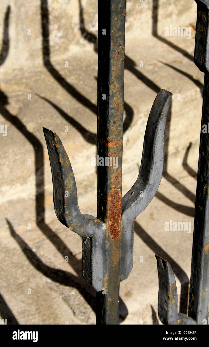 Rusted iron railings casting shadows on stone steps Stock Photo - Alamy