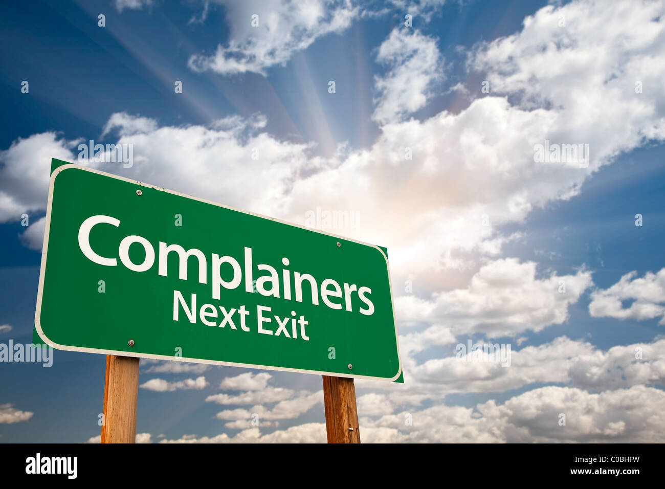 Complainers Green Road Sign with Dramatic Clouds, Sun Rays and Sky ...